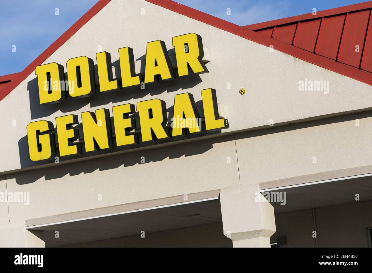 A logo sign outside of a Dollar General retail store location in ...