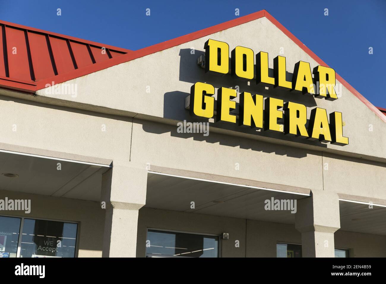A logo sign outside of a Dollar General retail store location in ...