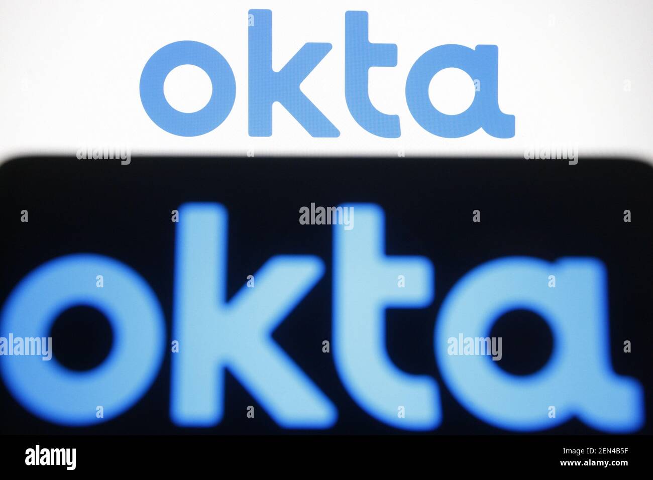 In this photo illustration an Okta logo is seen on a smartphone and a ...