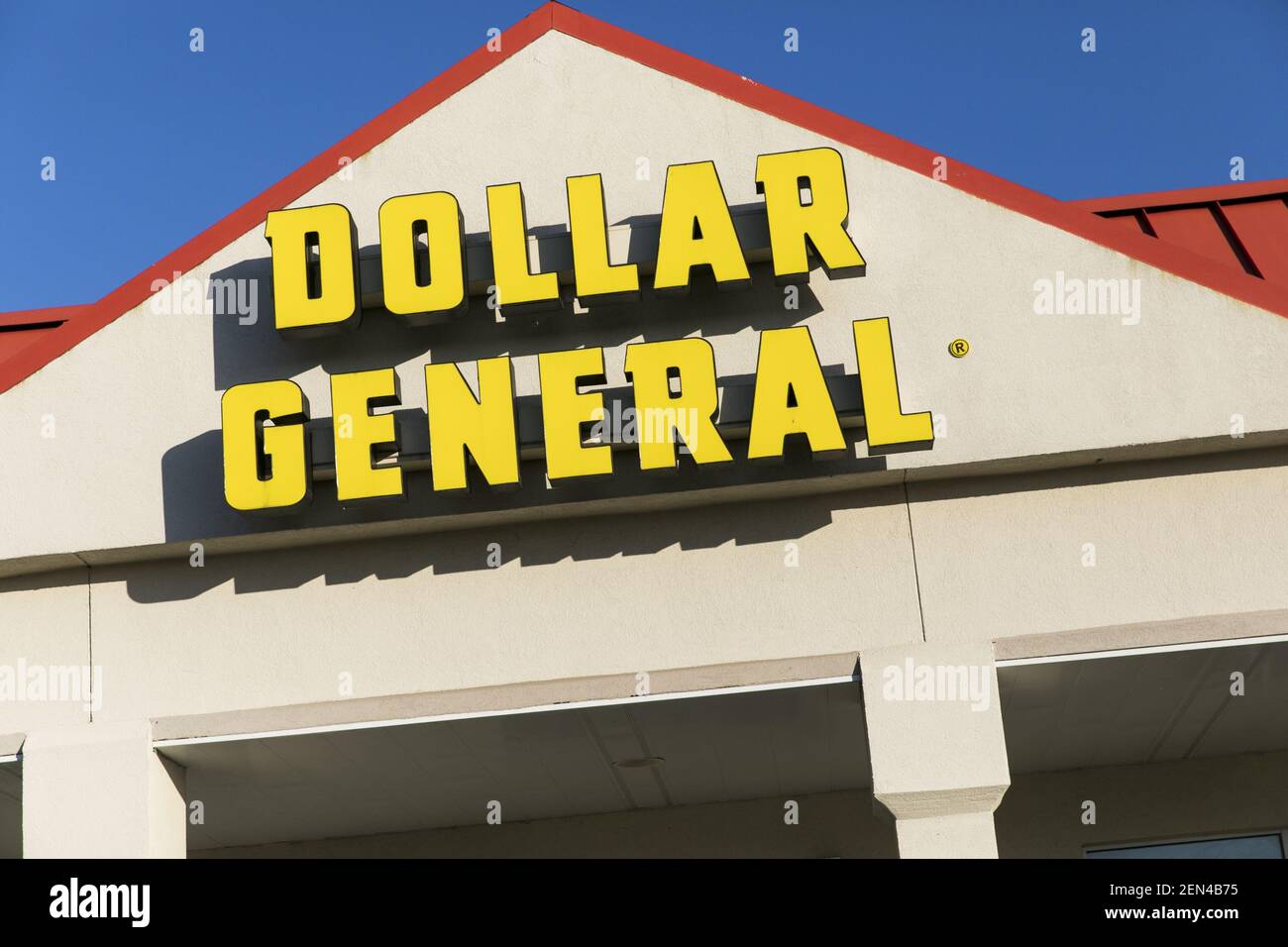 A logo sign outside of a Dollar General retail store location in ...