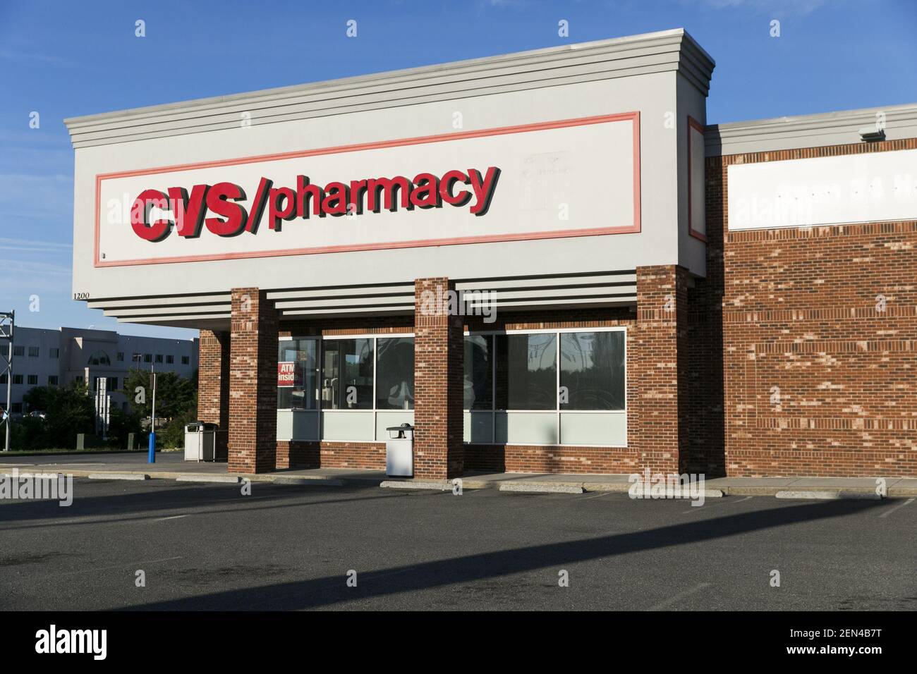 A logo sign outside of a CVS Pharmacy retail store location in ...
