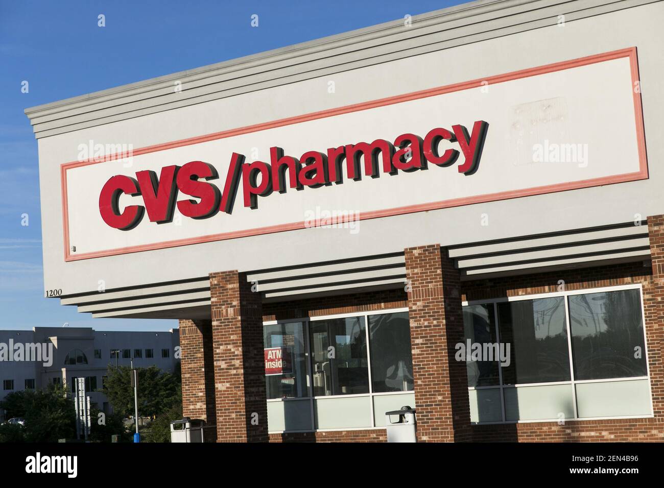 A logo sign outside of a CVS Pharmacy retail store location in ...