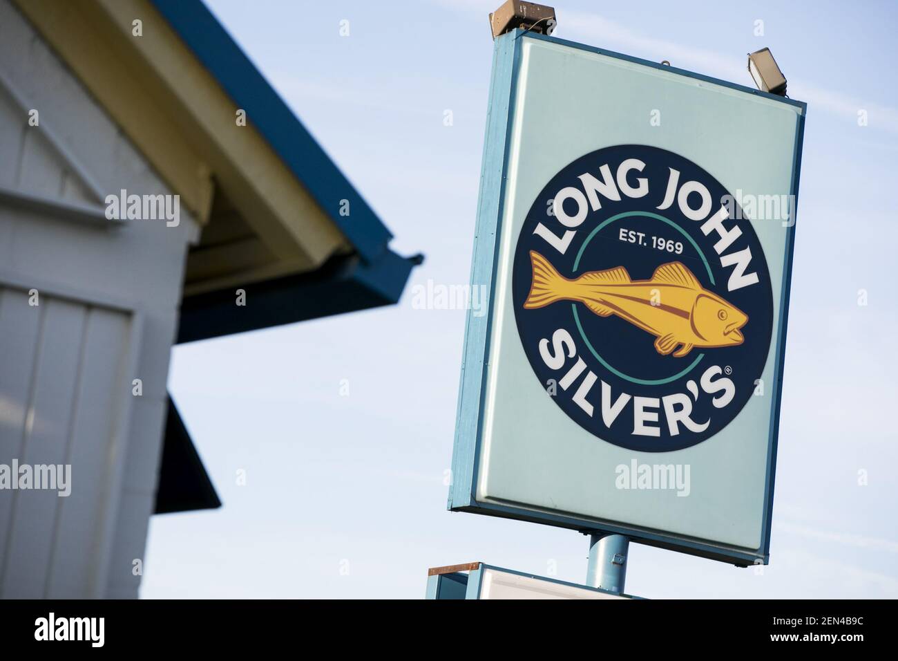 A logo sign outside of a Long John Silver's fast food restaurant ...