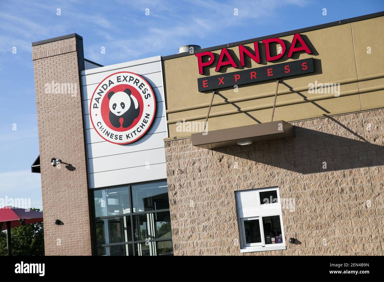 A logo sign outside of a Panda Express fast food restaurant location in ...