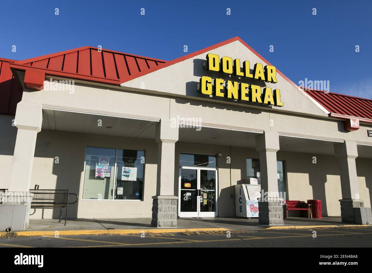 A logo sign outside of a Dollar General retail store location in ...