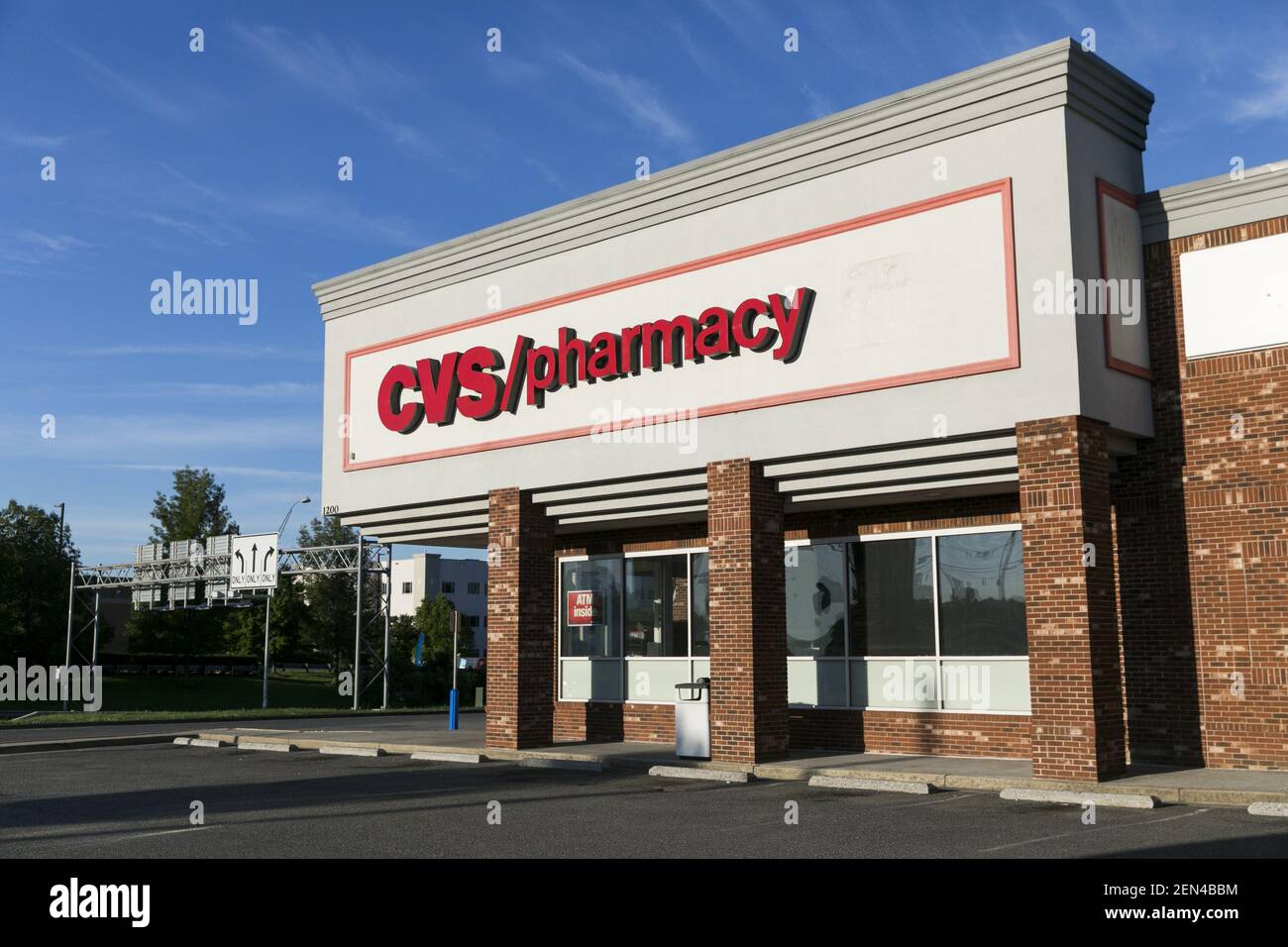 A logo sign outside of a CVS Pharmacy retail store location in ...