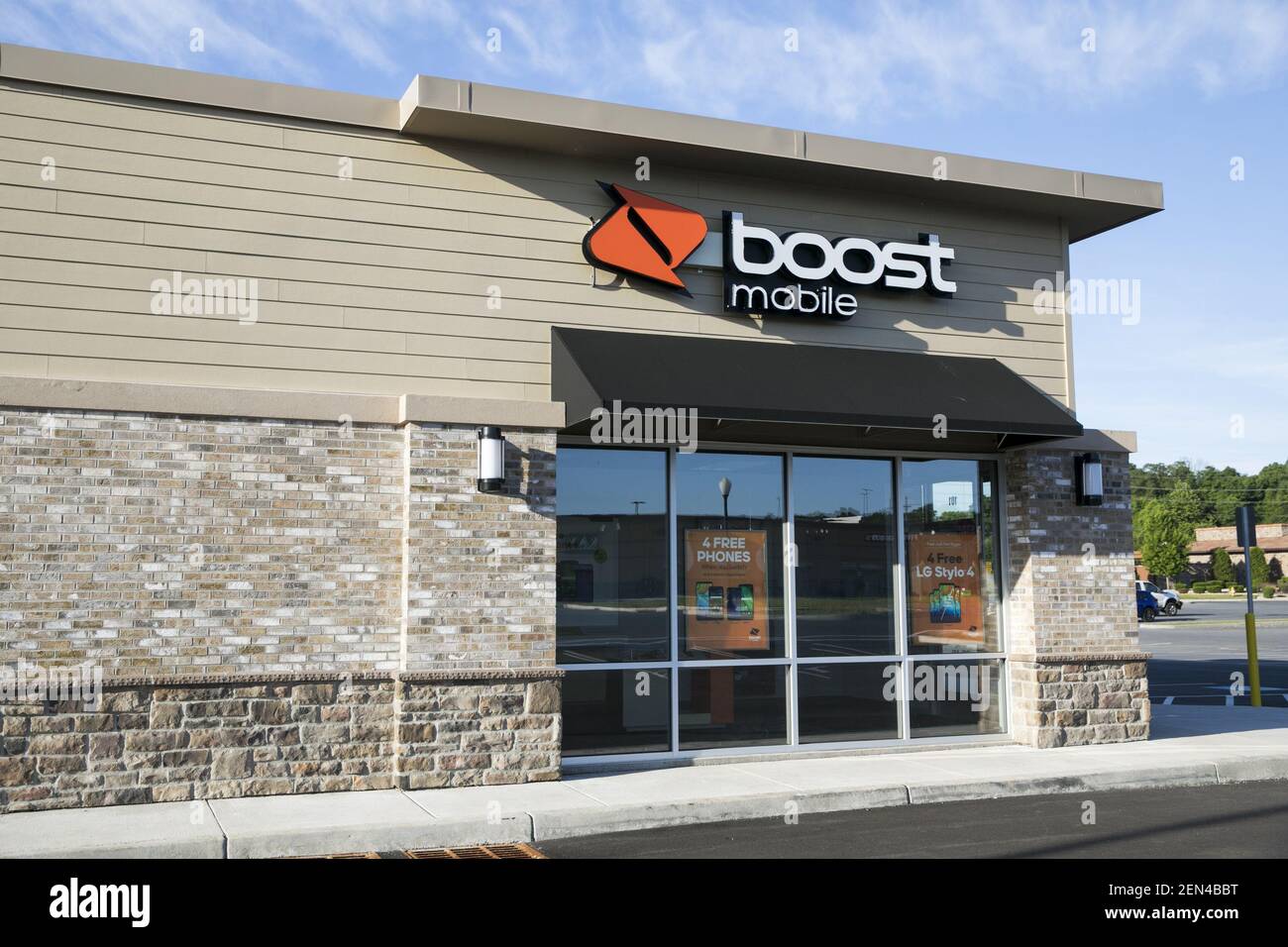A logo sign outside of a Boost Mobile retail store location in ...