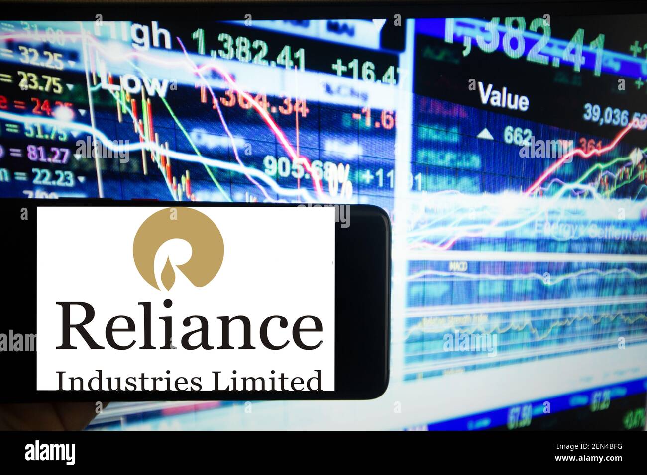 In this photo ullustration the logo of Reliance Industries Limited is seen on a smartphone next ...