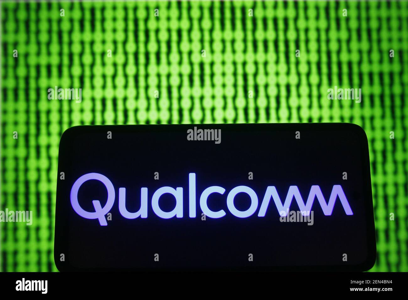 In this photo illustration a Qualcomm logo is seen on a smartphone ...
