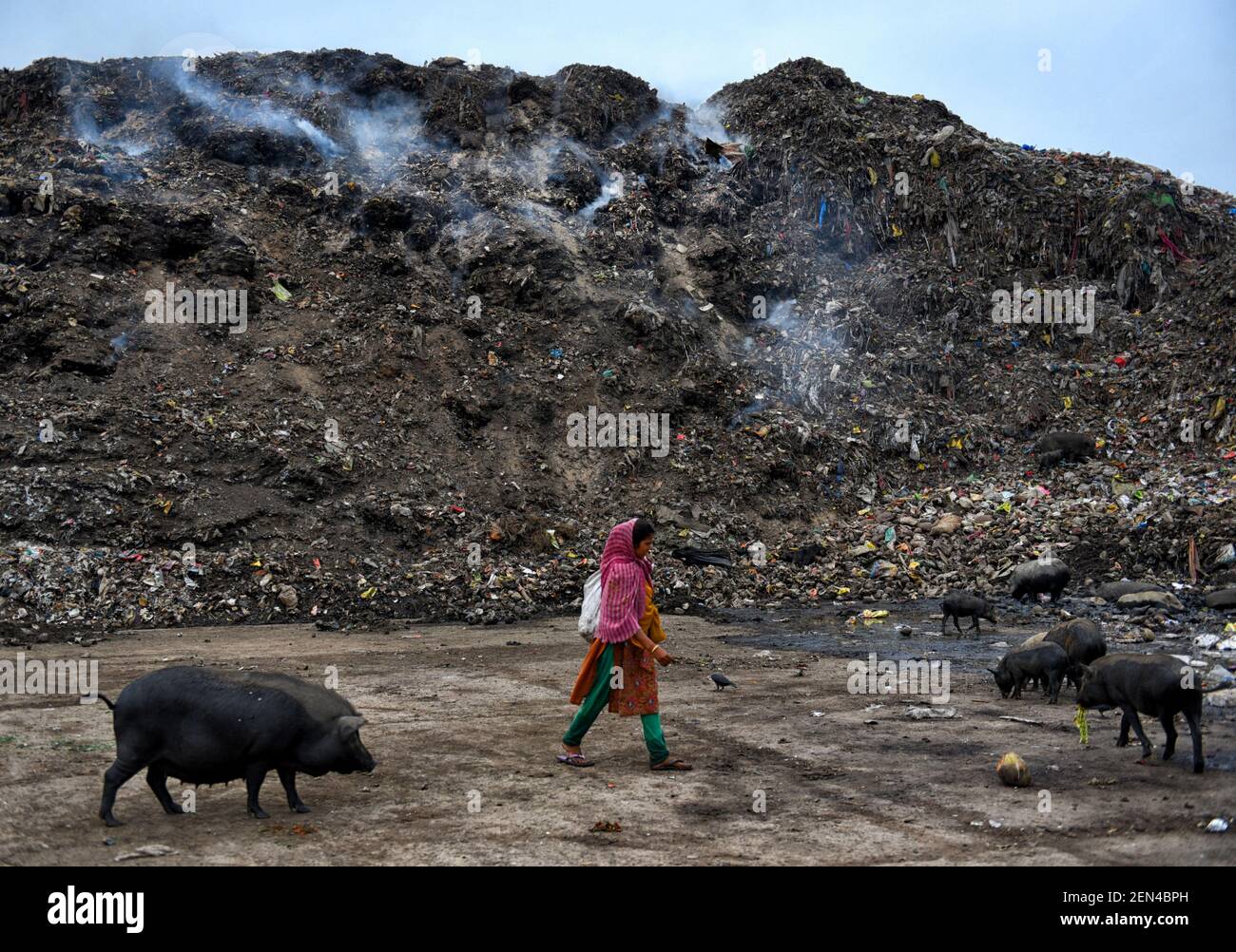 Poor woman collects scrap from a dump yard on world Environment day ...