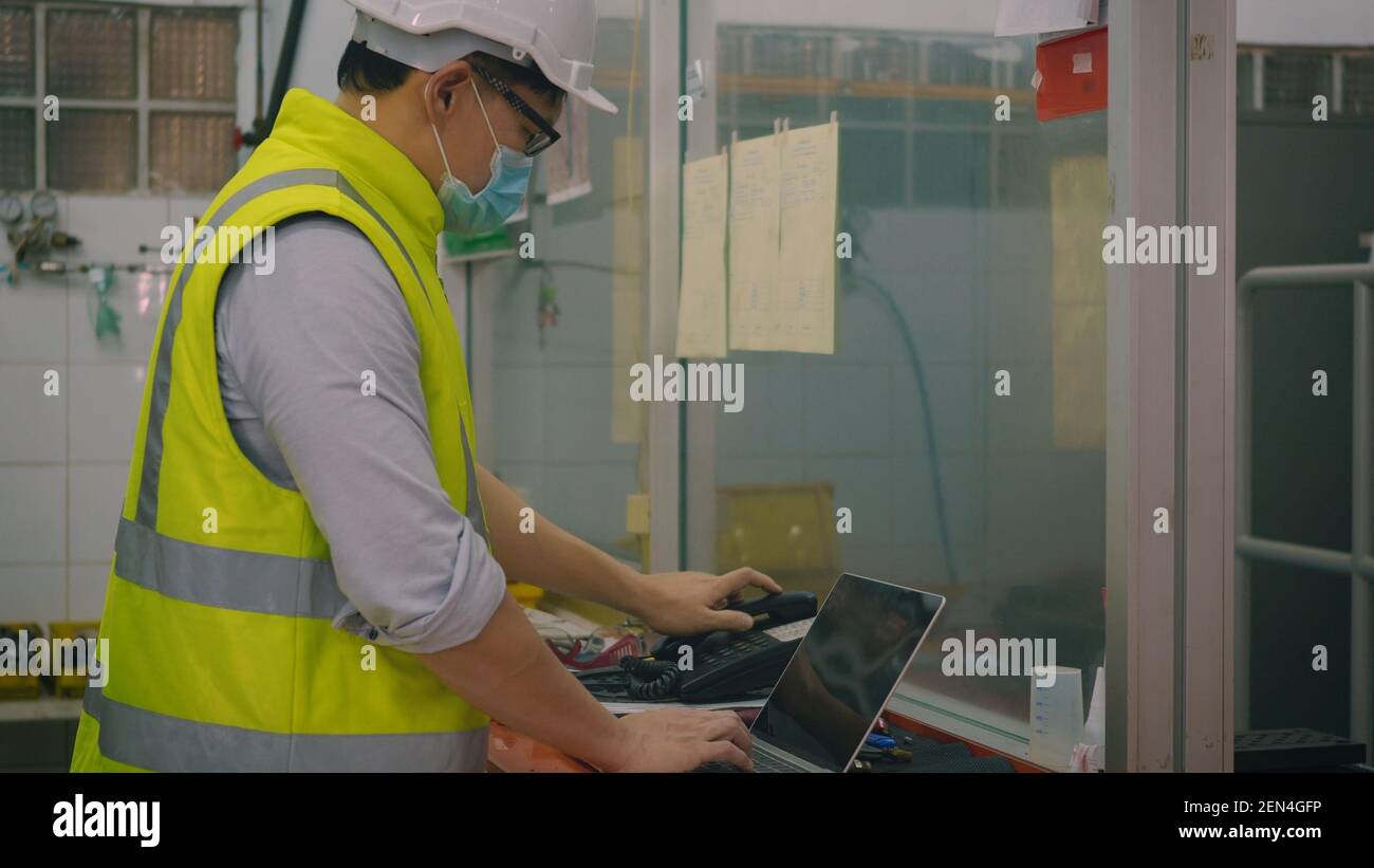 Asian factory worker man offering phone receiver as business ...