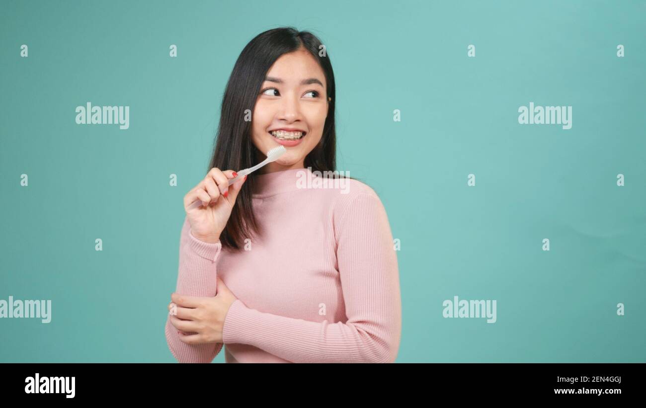 Asian young beautiful woman smile brushing teeth dancing enjoying music ...