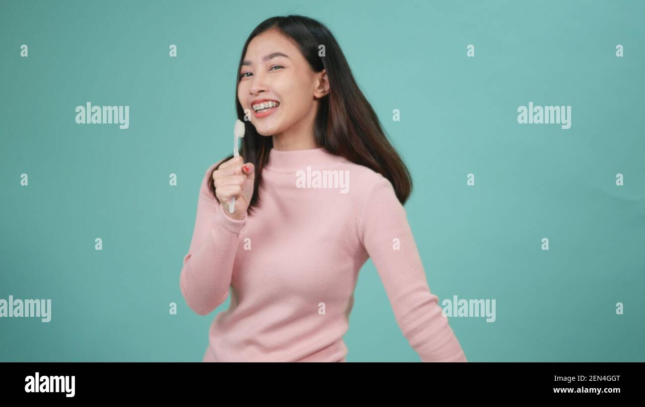 Asian young beautiful woman smile brushing teeth dancing enjoying music ...