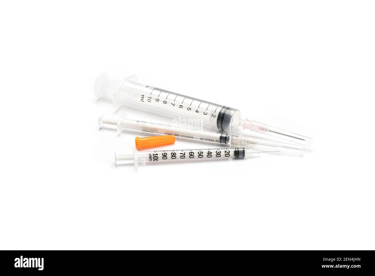 Multiple sizes of syringes are placed on white background. Isolated ...