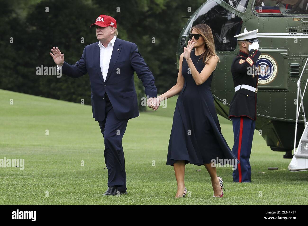 President Donald Trump and first lady Melania Trump walk on the South ...