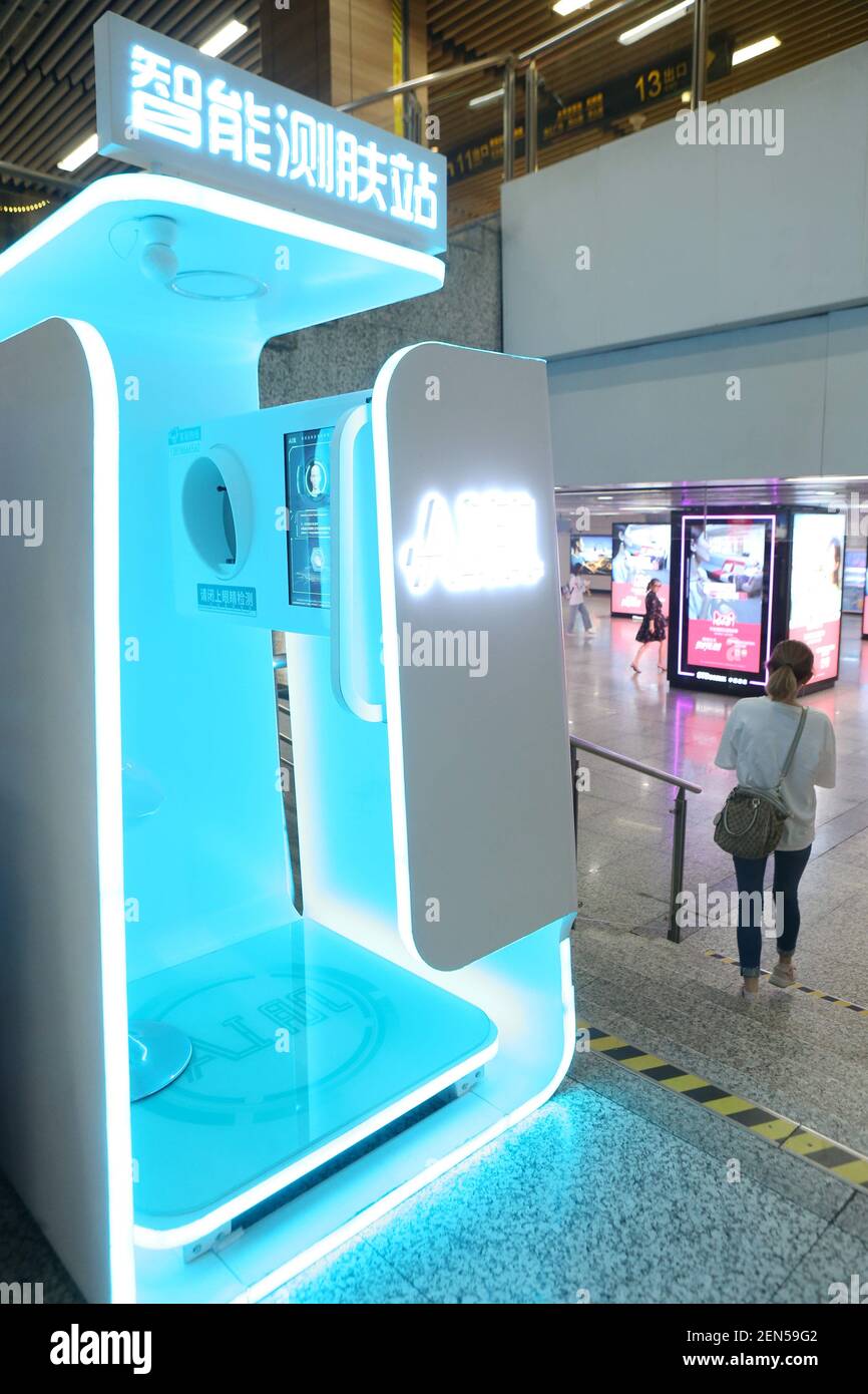 A passenger walks past the skin testing machine at a subway station in ...