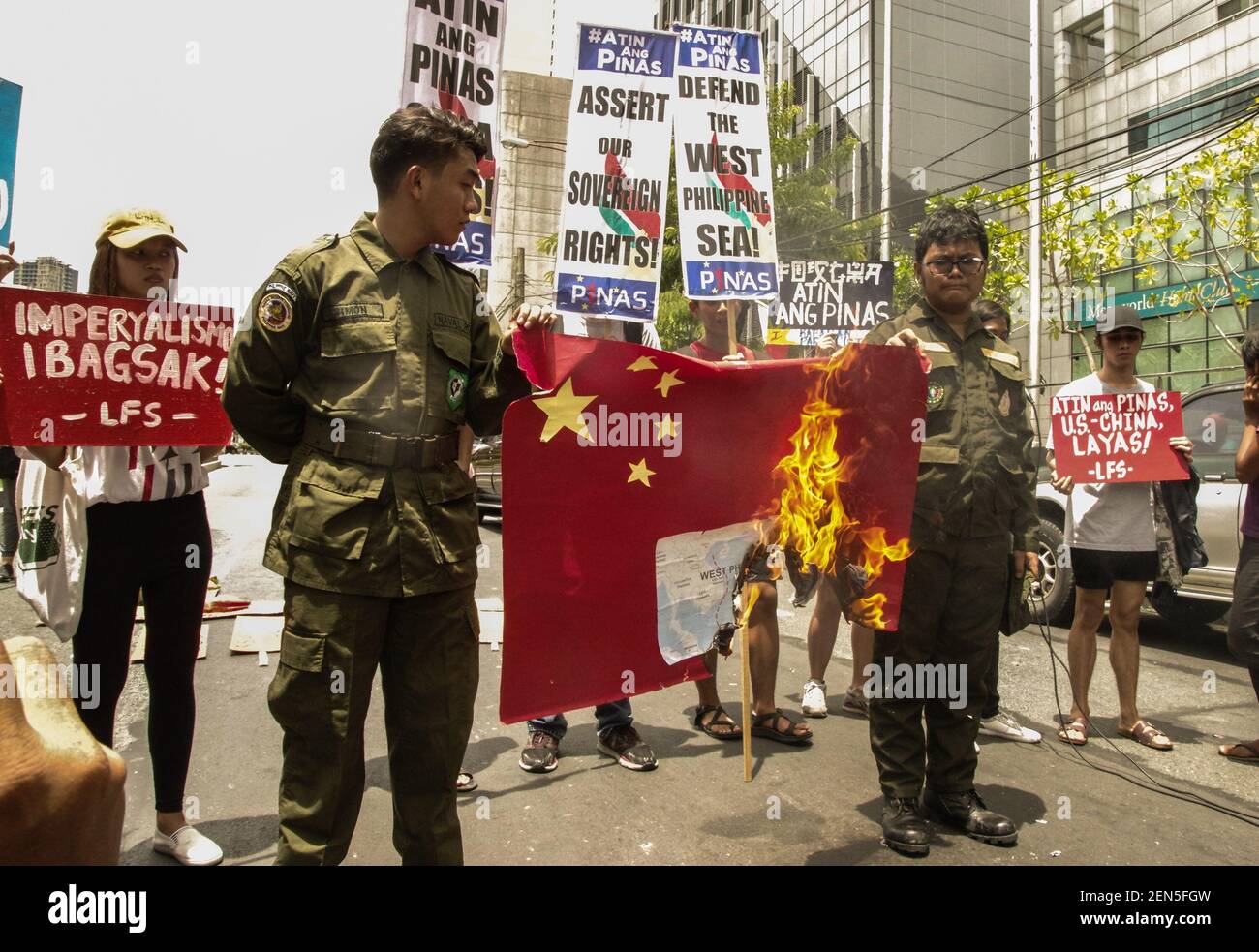 Militant groups burn a Chinese flag in front of Chinese Embassy in ...