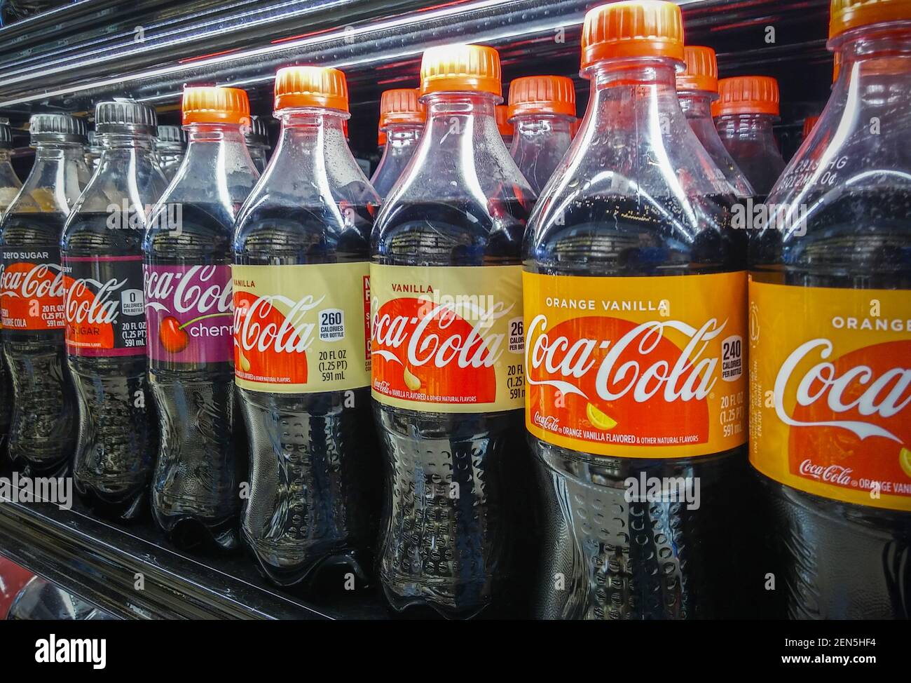 Bottles of various flavors of Coca-Cola in a supermarket cooler in New ...