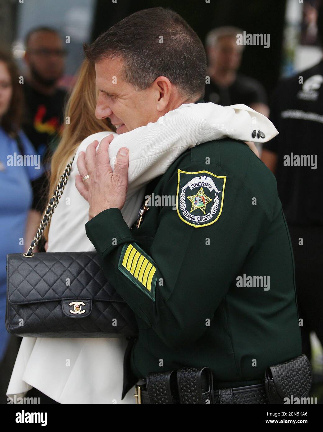 Orange County Sheriff John Mina hugs Barbara Poma, owner of the Pulse ...