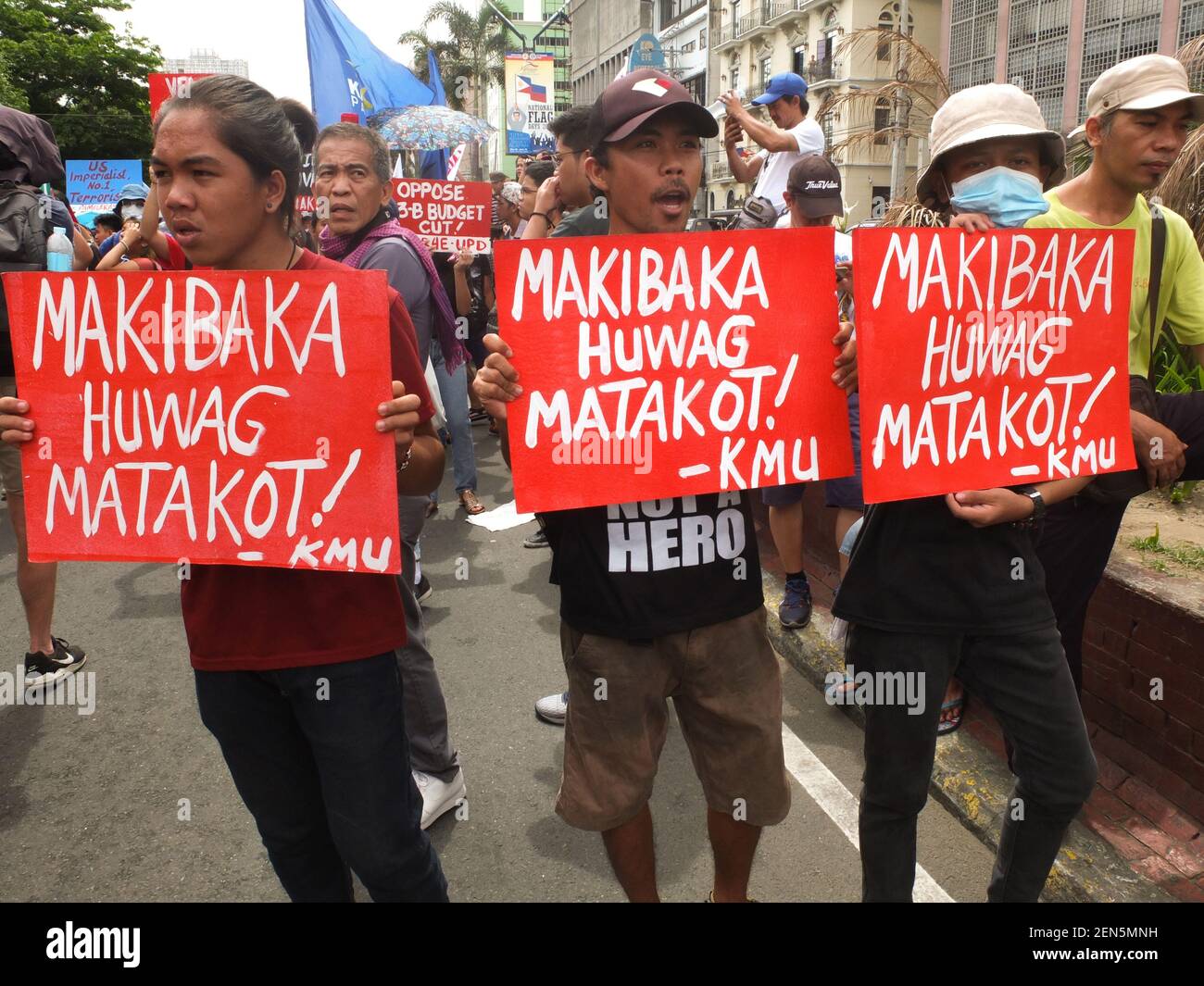 Members of the Kilusang Mayo Uno hold identical placards during the ...