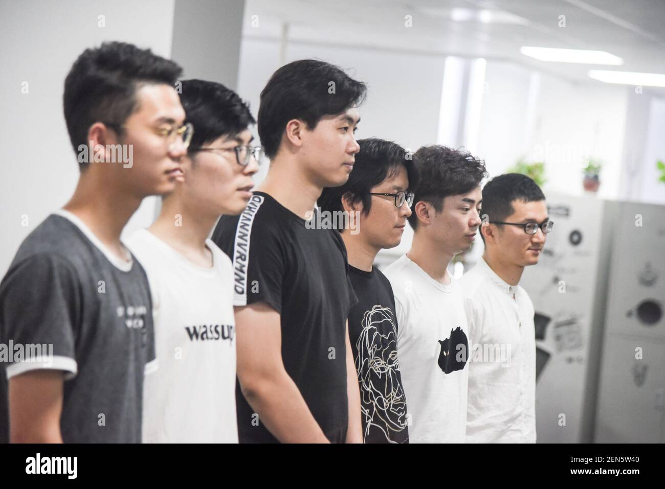 Chinese programmers are lined up to be examined by a doctor who ...