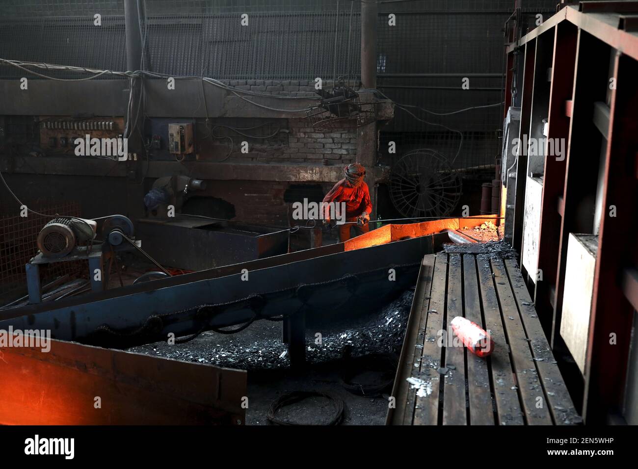 Worker are working in a steel factory in the densely populated slum ...