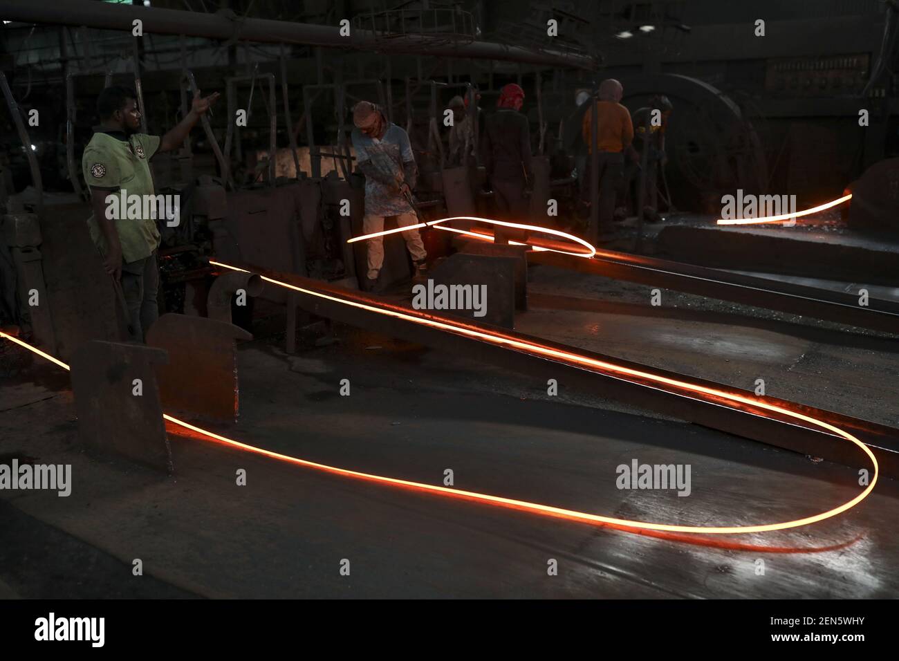 Worker are working in a steel factory in the densely populated slum ...