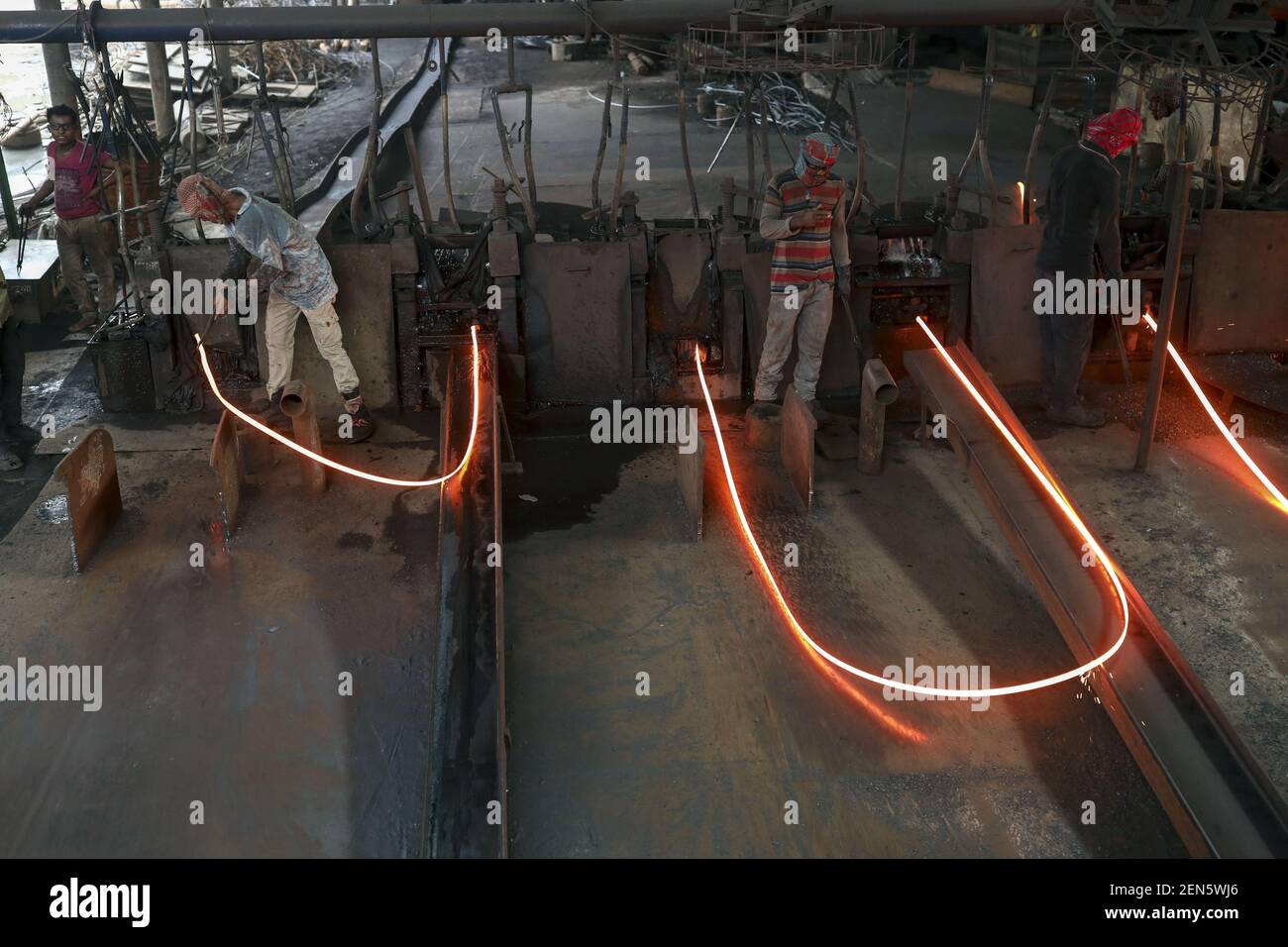 Worker are working in a steel factory in the densely populated slum ...