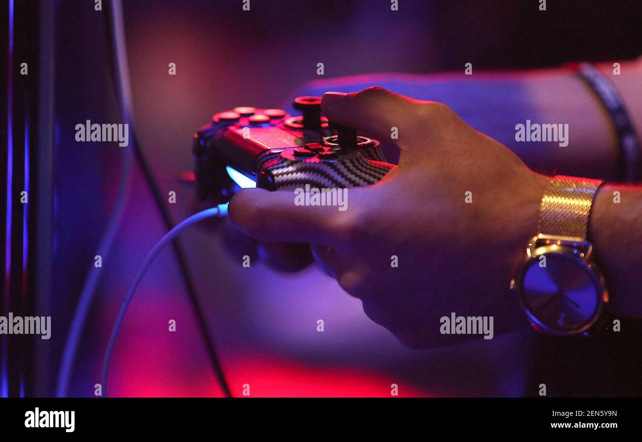 Orlando Magic player Daniel Tlais (DT) operates his game controller ...