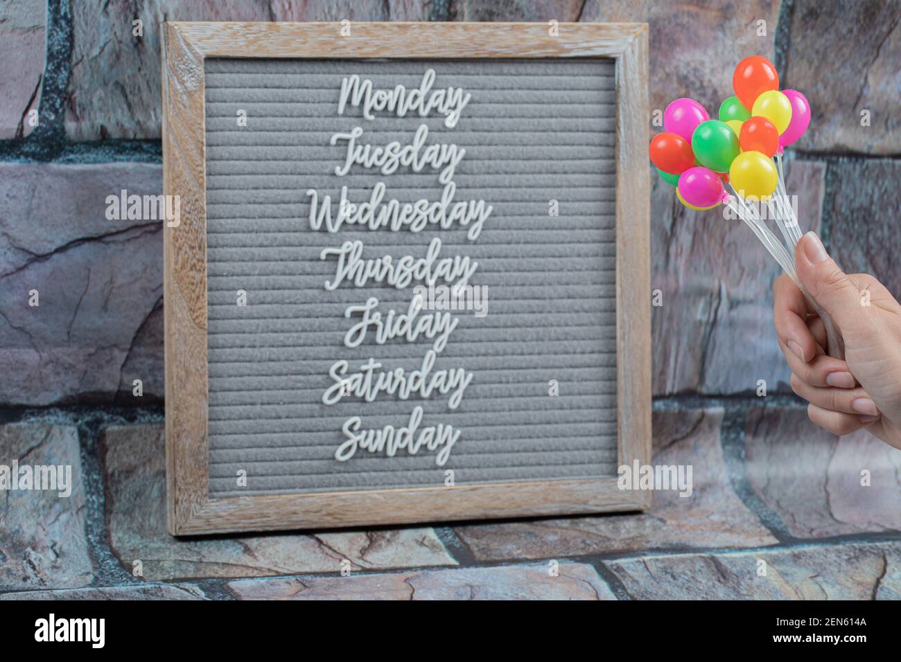 Happy weekdays poster written with letter symbols on the grey tissue ...