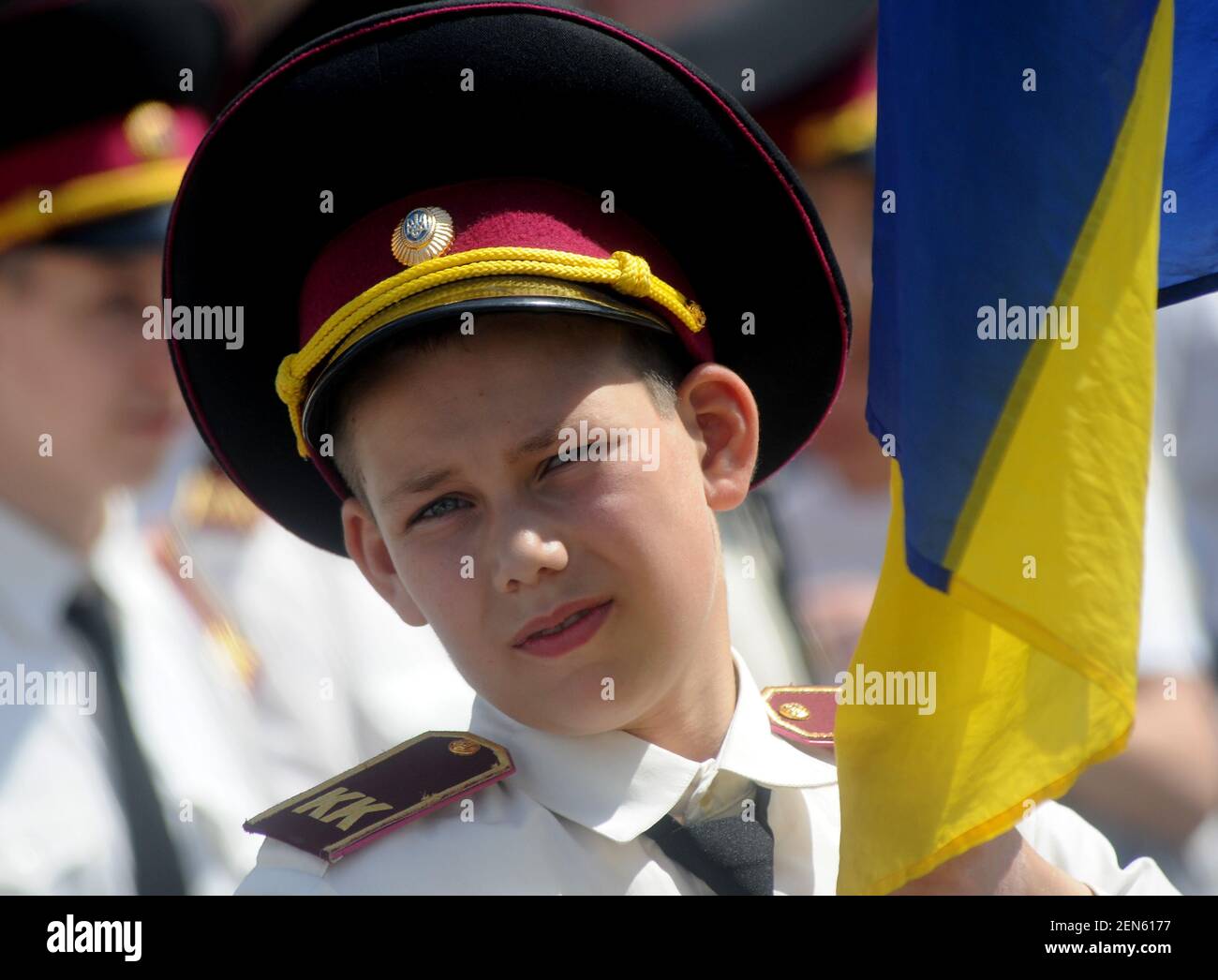 A cadet holds a Ukrainian flag during the ceremony. Holiday-graduation ...