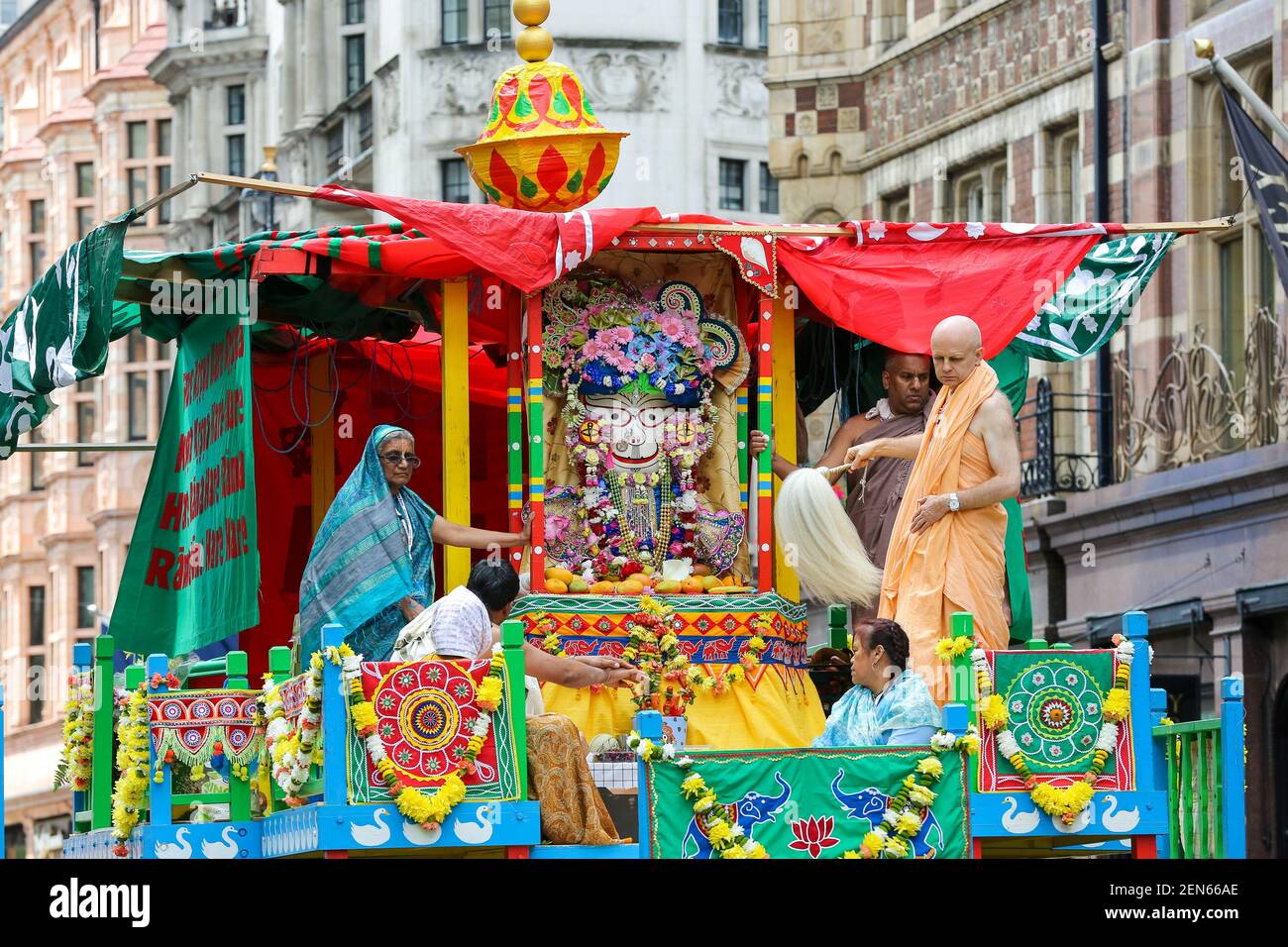 Priests are seen on the wooden chariot as Hare Krishna pilgrims and ...