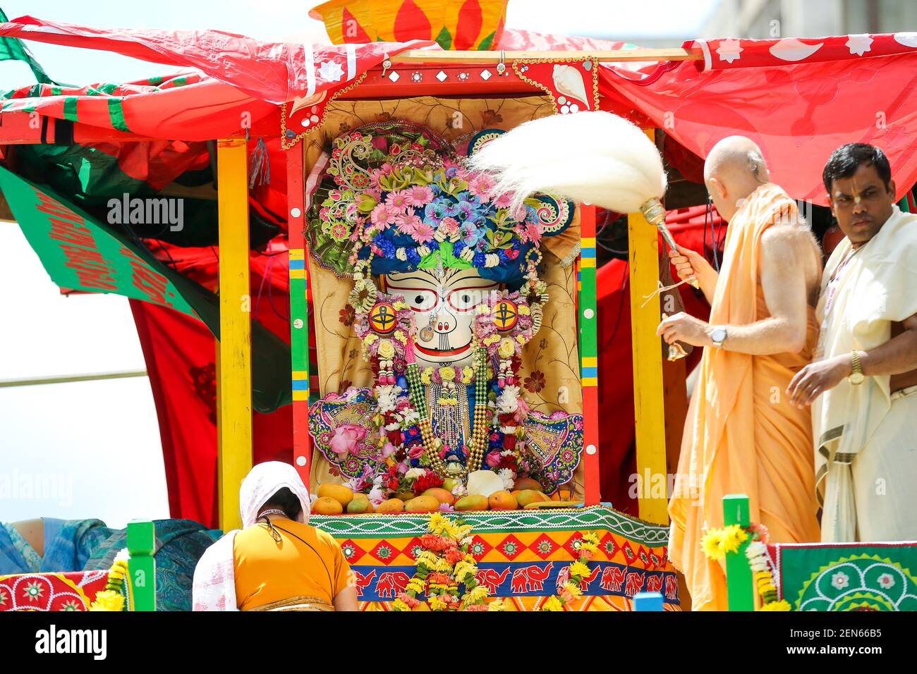 A priest is seen on the wooden chariot as Hare Krishna pilgrims and ...