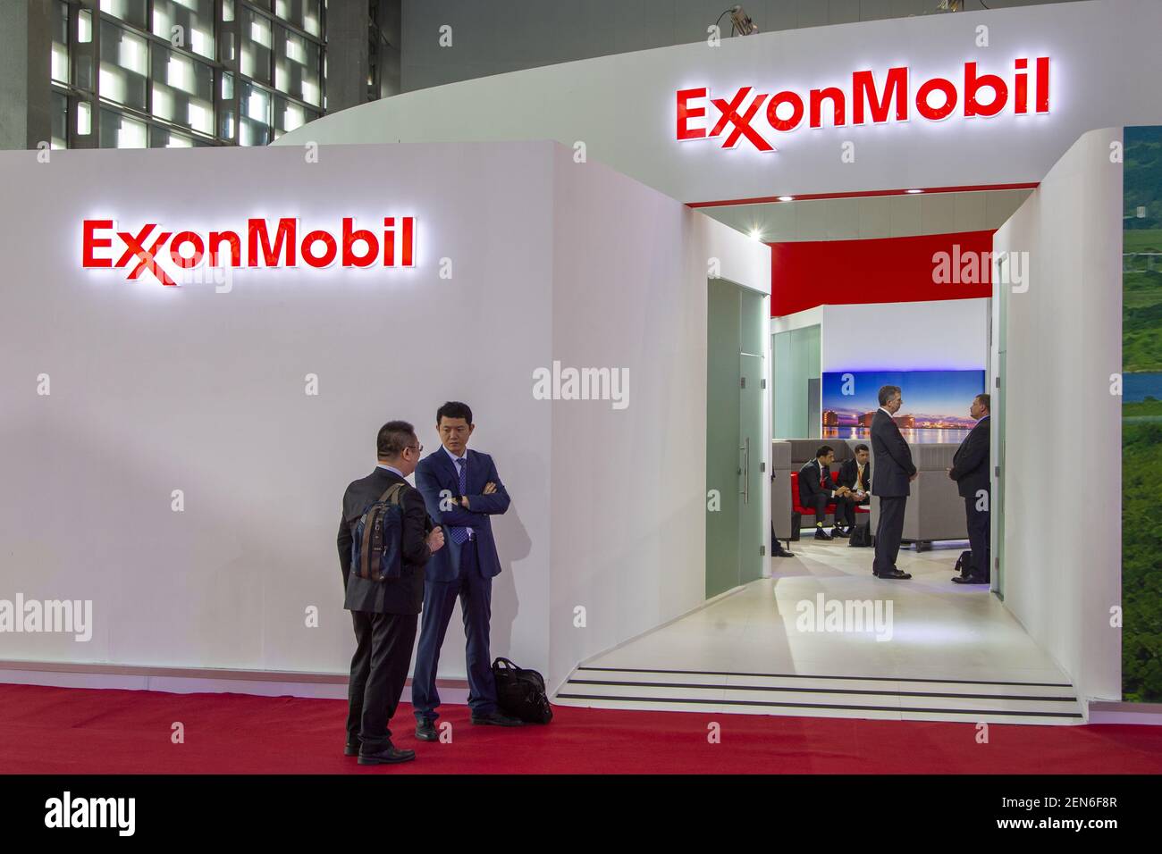 --FILE--People visit the stand of US-based ExxonMobil Corp during an ...