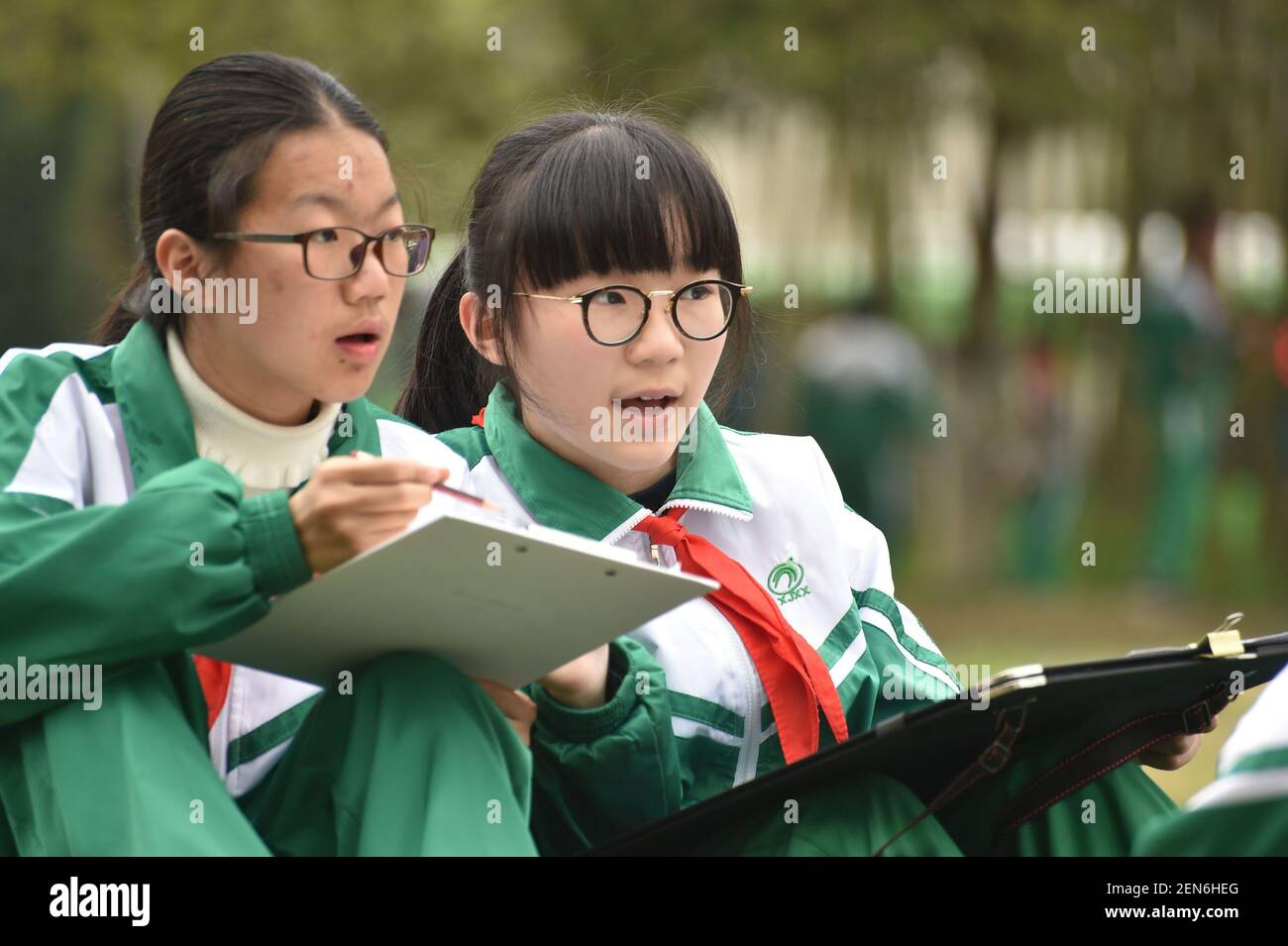 Near-sighted young Chinese girl students wearing glasses make drawings ...