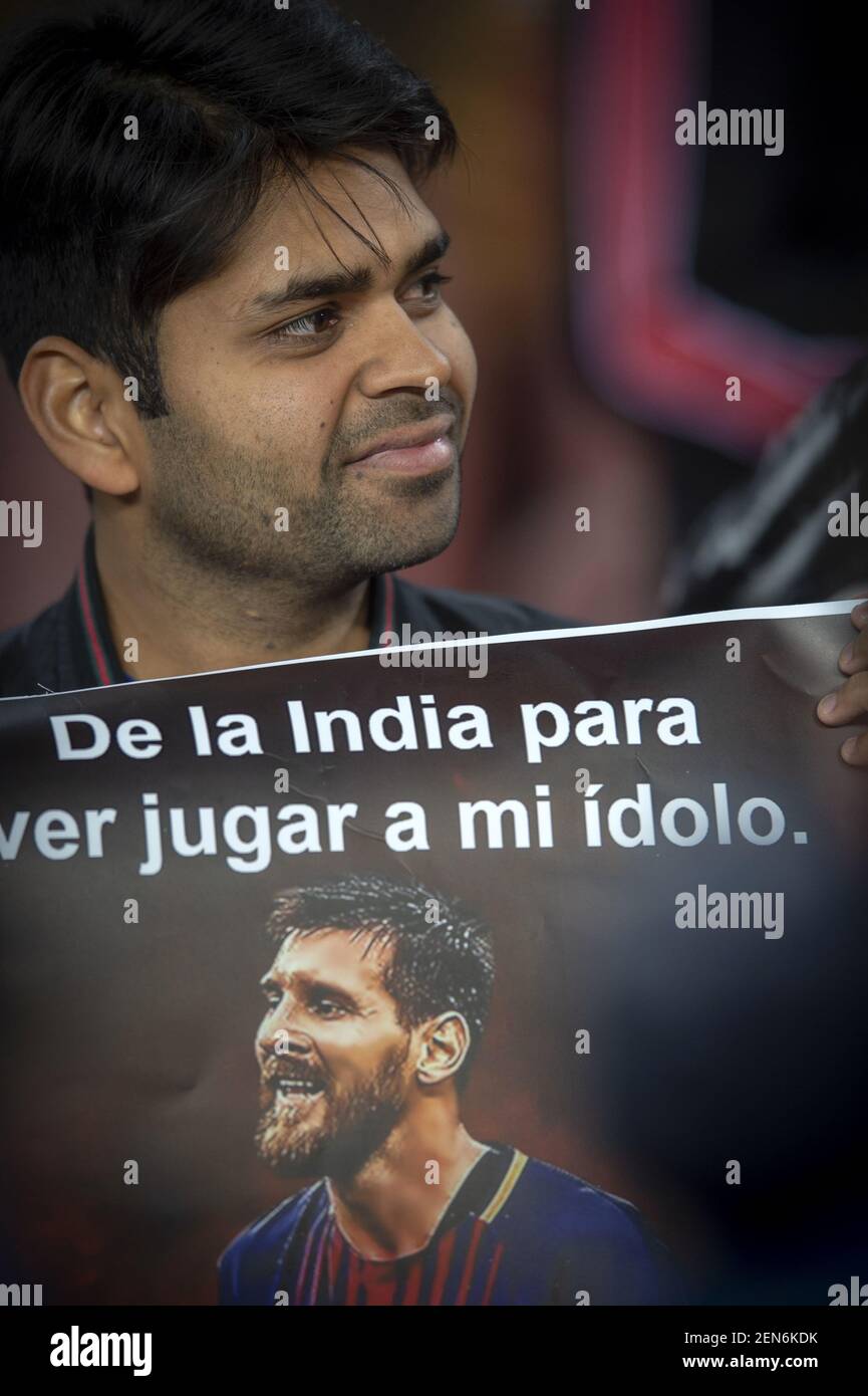 An Indian football fan displays a poster saying "I came from India to ...