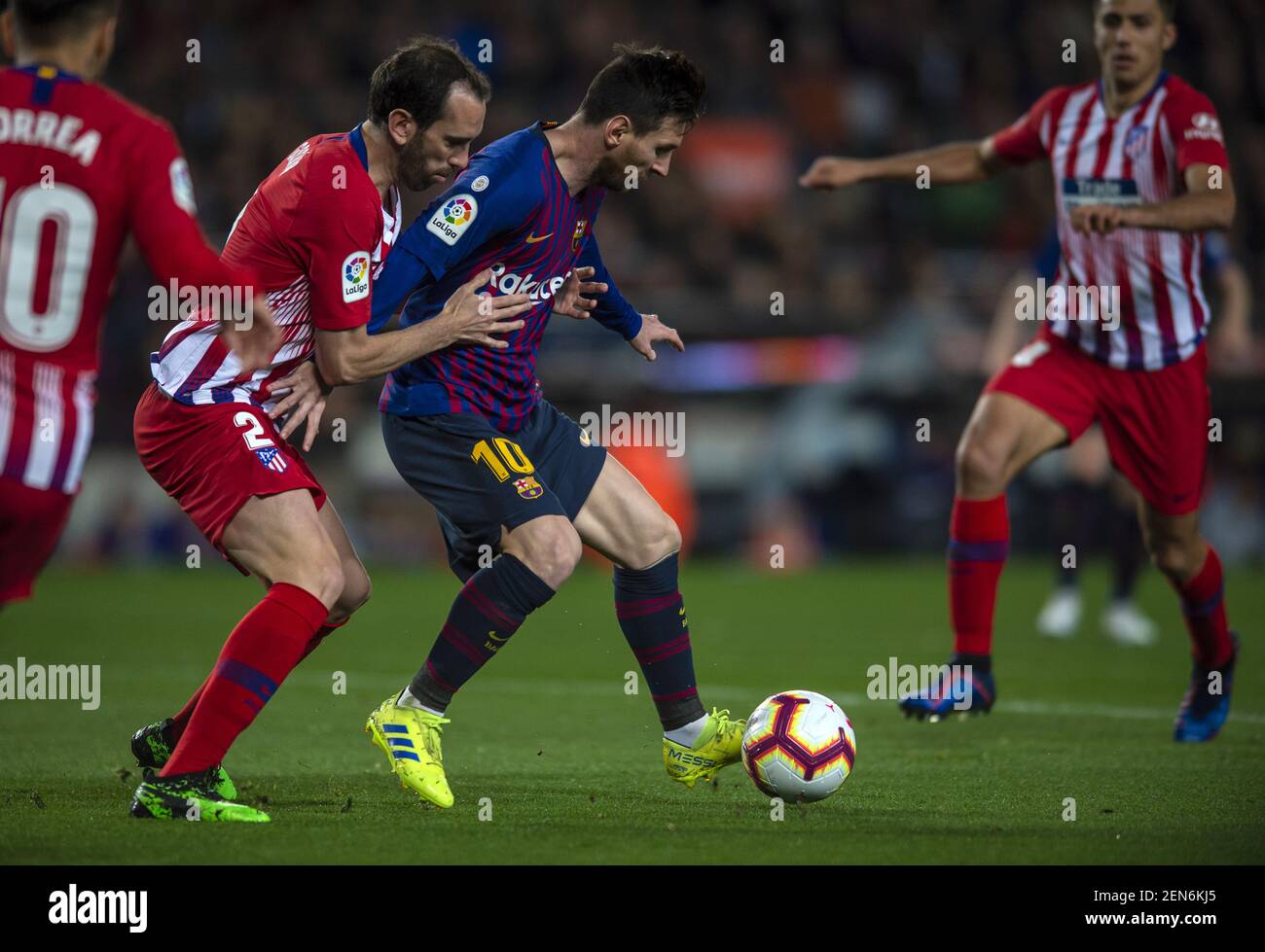 Lionel Messi of FC Barcelona, second right, challenges Diego Godin of ...