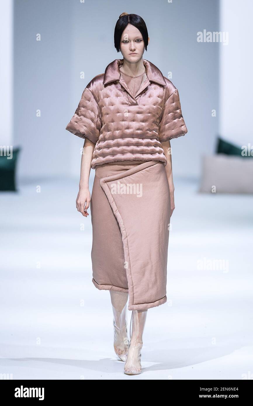 A model displays a new creation at the Evening show during the Shanghai ...