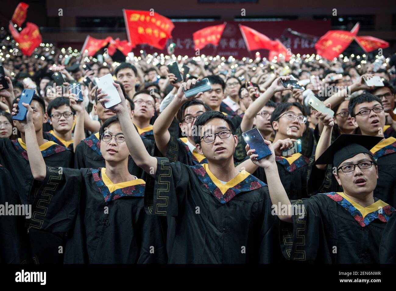 Undergraduates dressed in academic gowns take part in a graduation ...