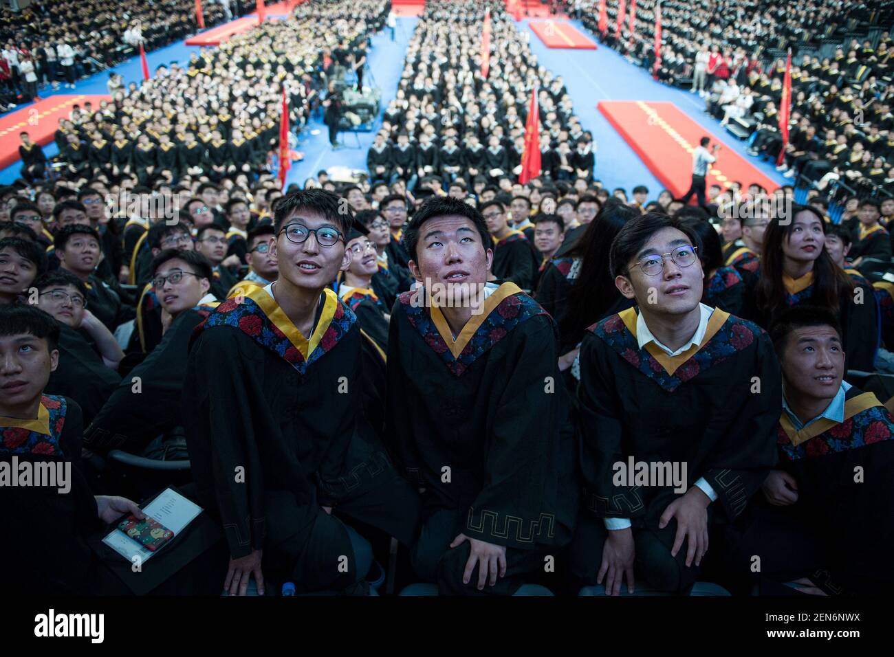 Undergraduates dressed in academic gowns take part in a graduation ...