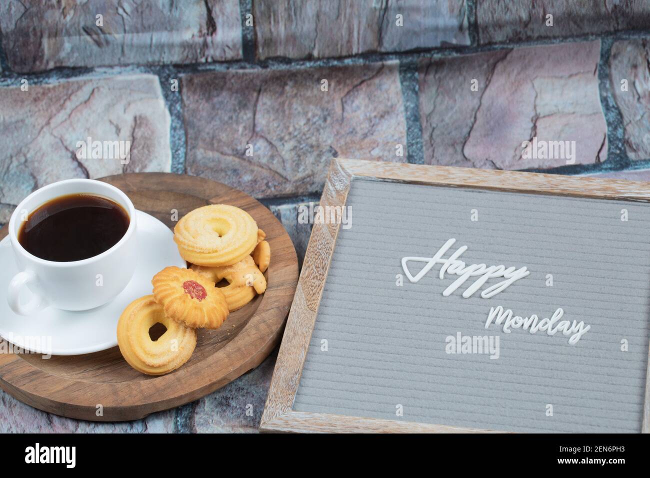 Happy monday poster with a cup of drink and cookies around Stock Photo ...