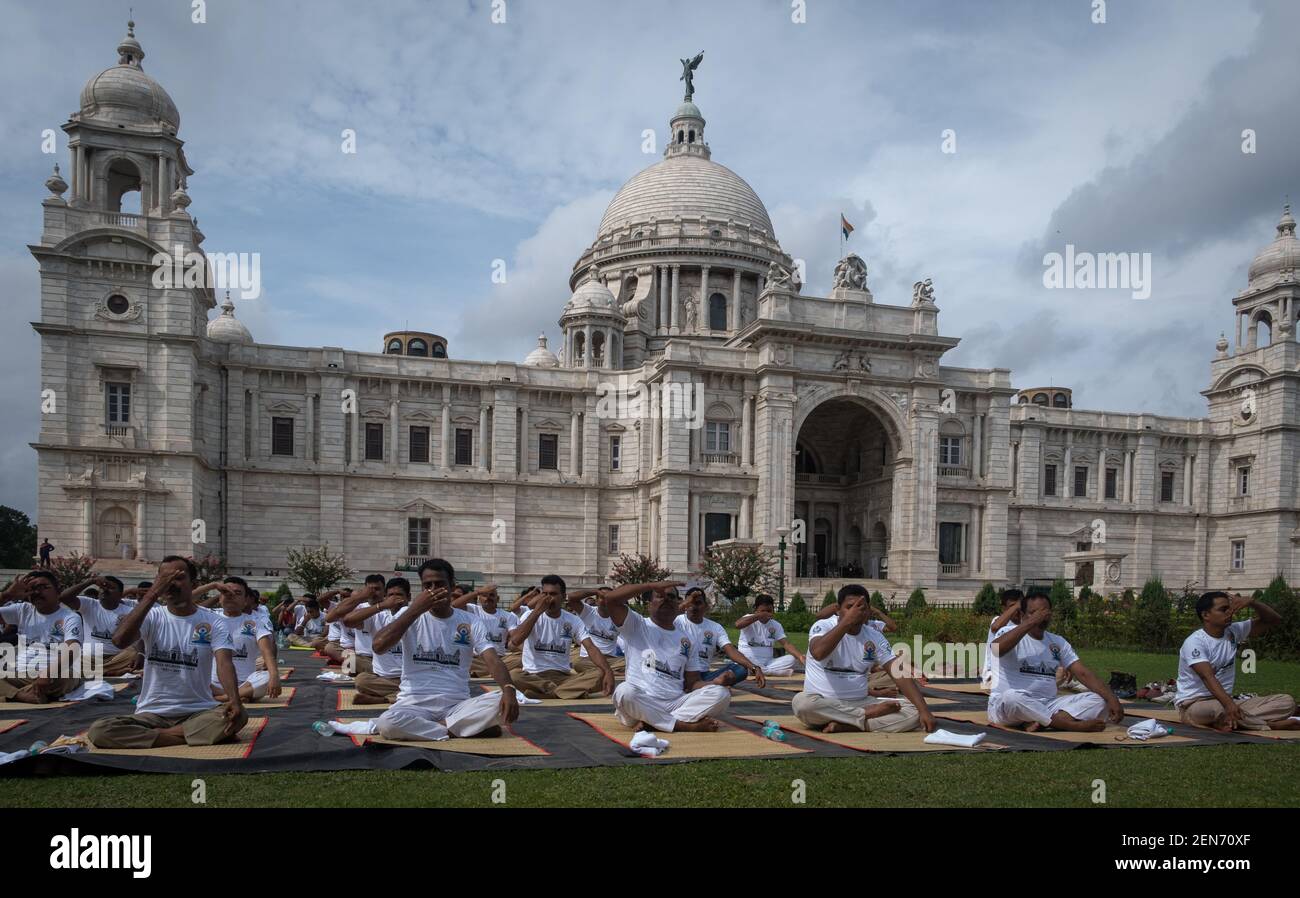 People practice yoga positions as part of a World Yoga day celebration in Kolkata, India on June ...
