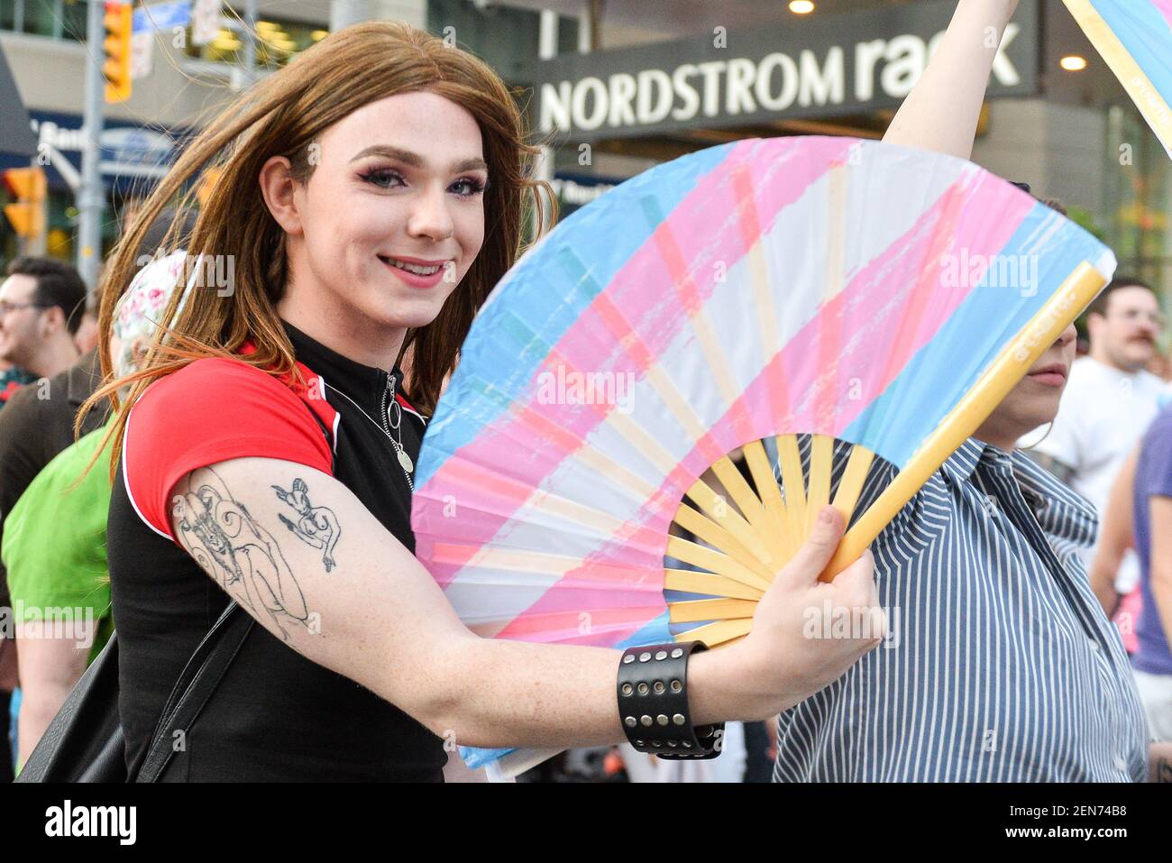 A woman with the LGBT fan during the Trans march. Spectators displayed ...