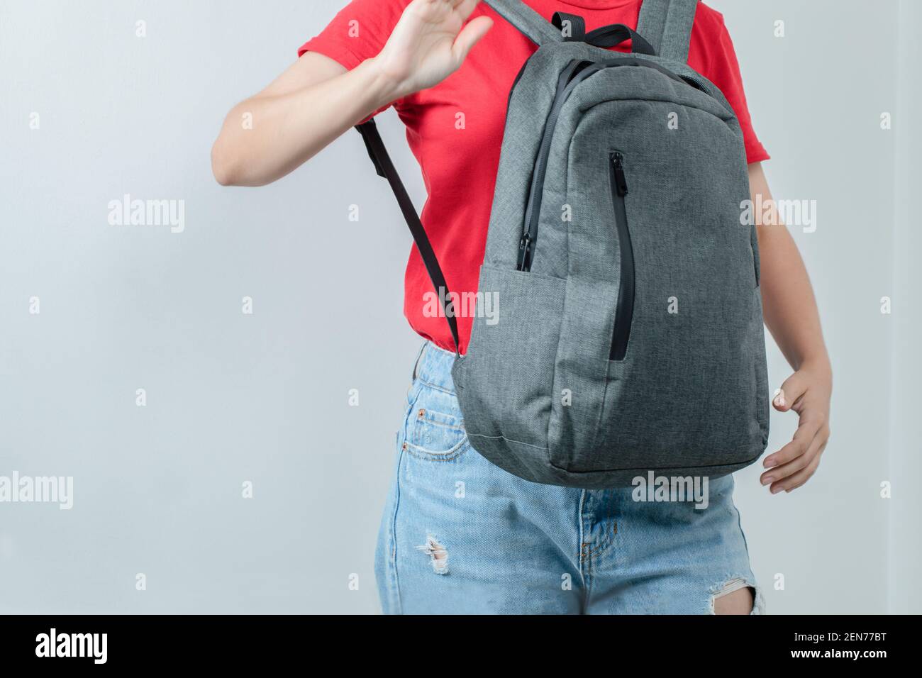Student wearing her backpack at the front Stock Photo - Alamy