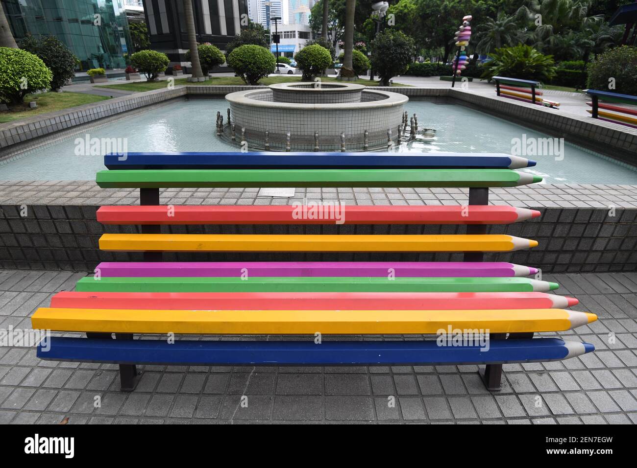 Colored pencil benches are pictured at a square amongst office ...