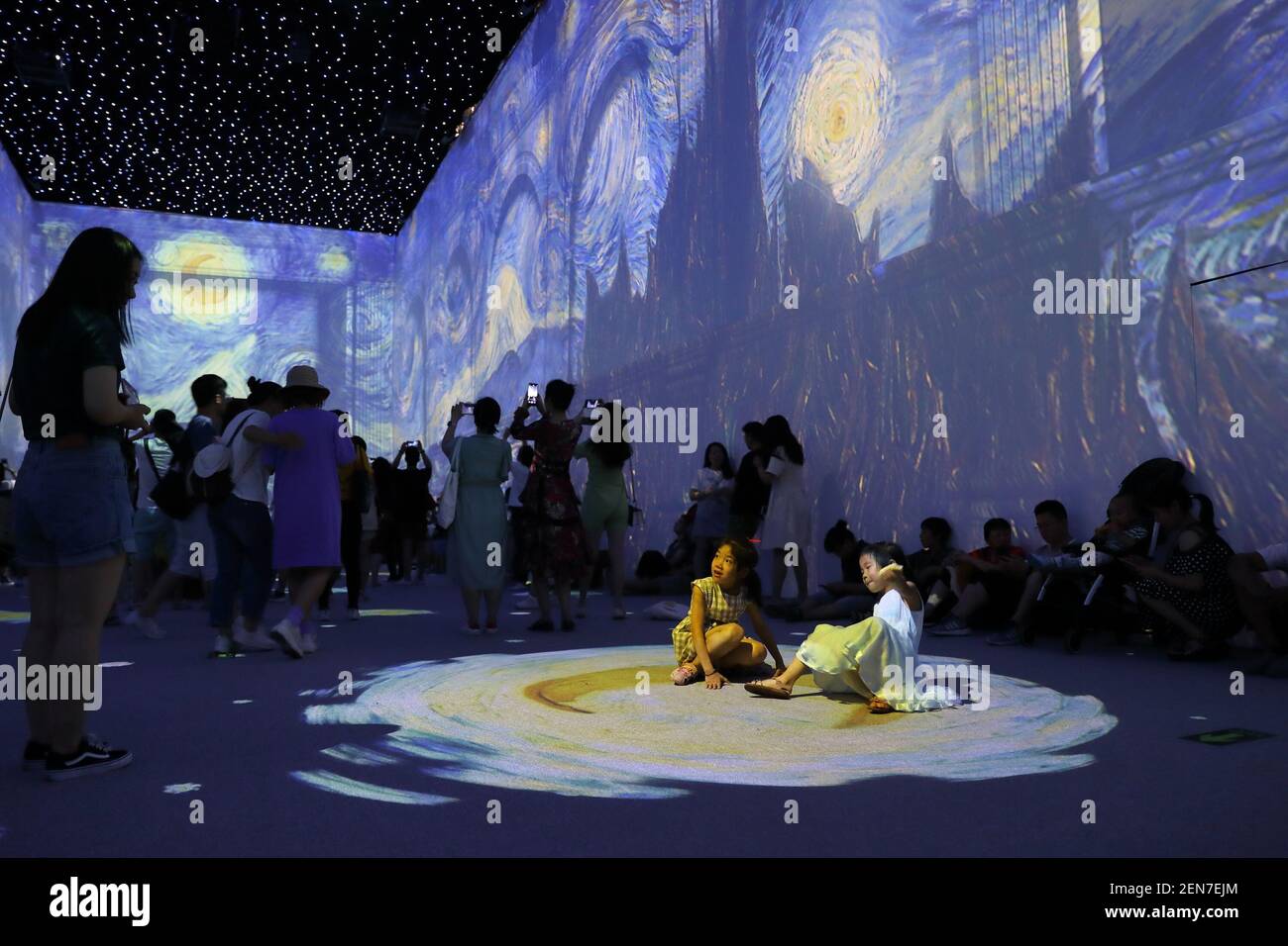 Visitors view or take pictures of a projection of art by Dutch post ...