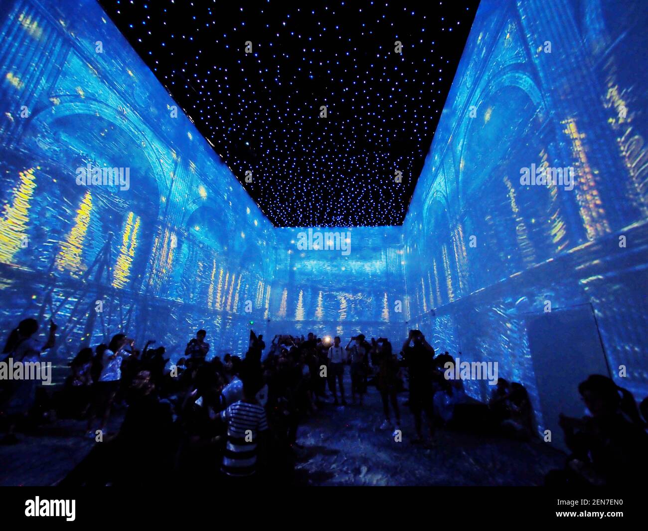 Visitors view or take pictures of a projection of art by Dutch post ...