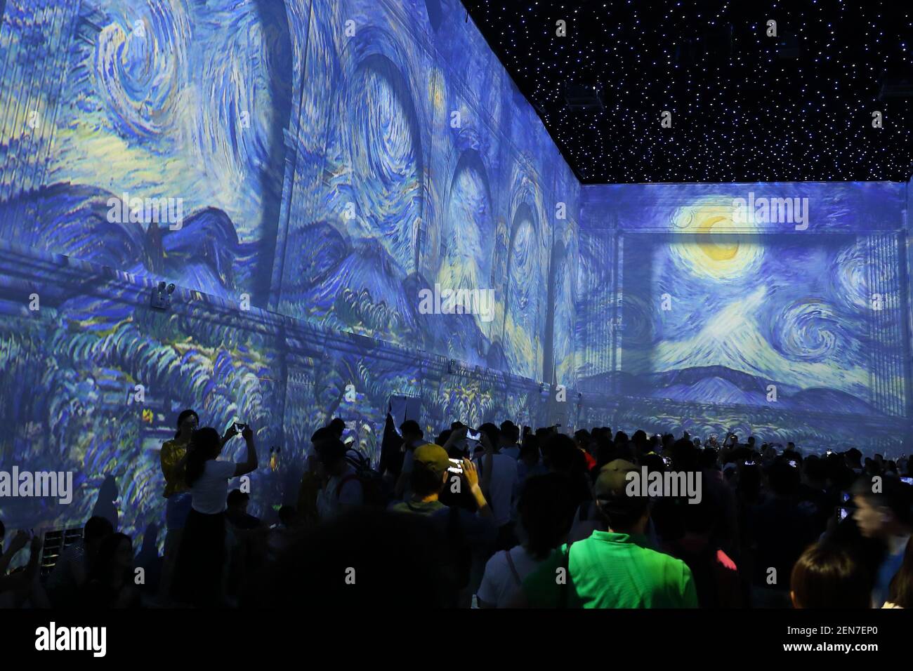 Visitors view or take pictures of a projection of art by Dutch post ...