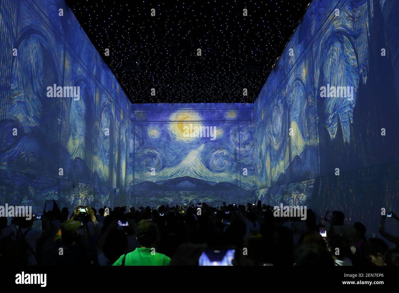 Visitors view or take pictures of a projection of art by Dutch post ...