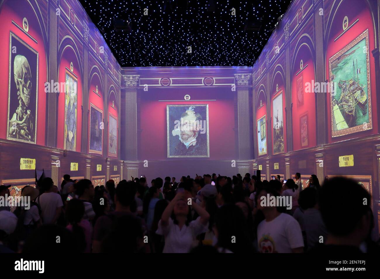 Visitors view or take pictures of a projection of art by Dutch post ...